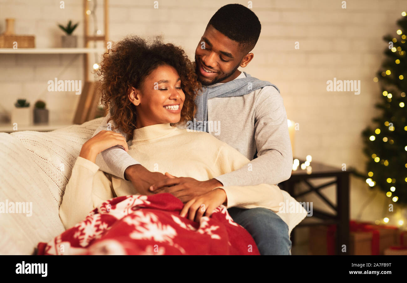 Cute couple cuddling on couch hi-res stock photography and images - Alamy