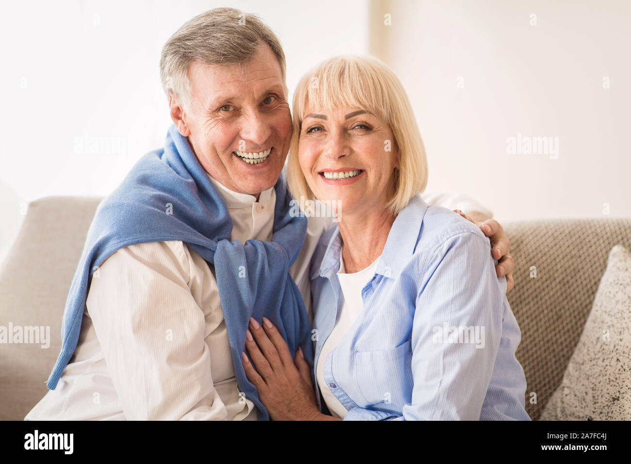 Happy mature couple embracing and smiling to camera Stock Photo - Alamy