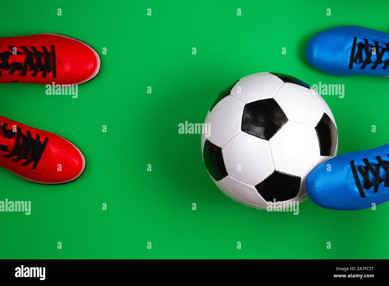 Top view to soccer ball between soccer players feets on green ...