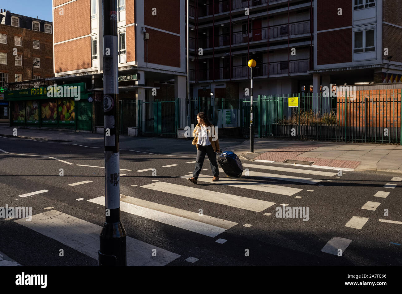 Lady crossing the road in the early morning in Holborn, London UK Stock ...