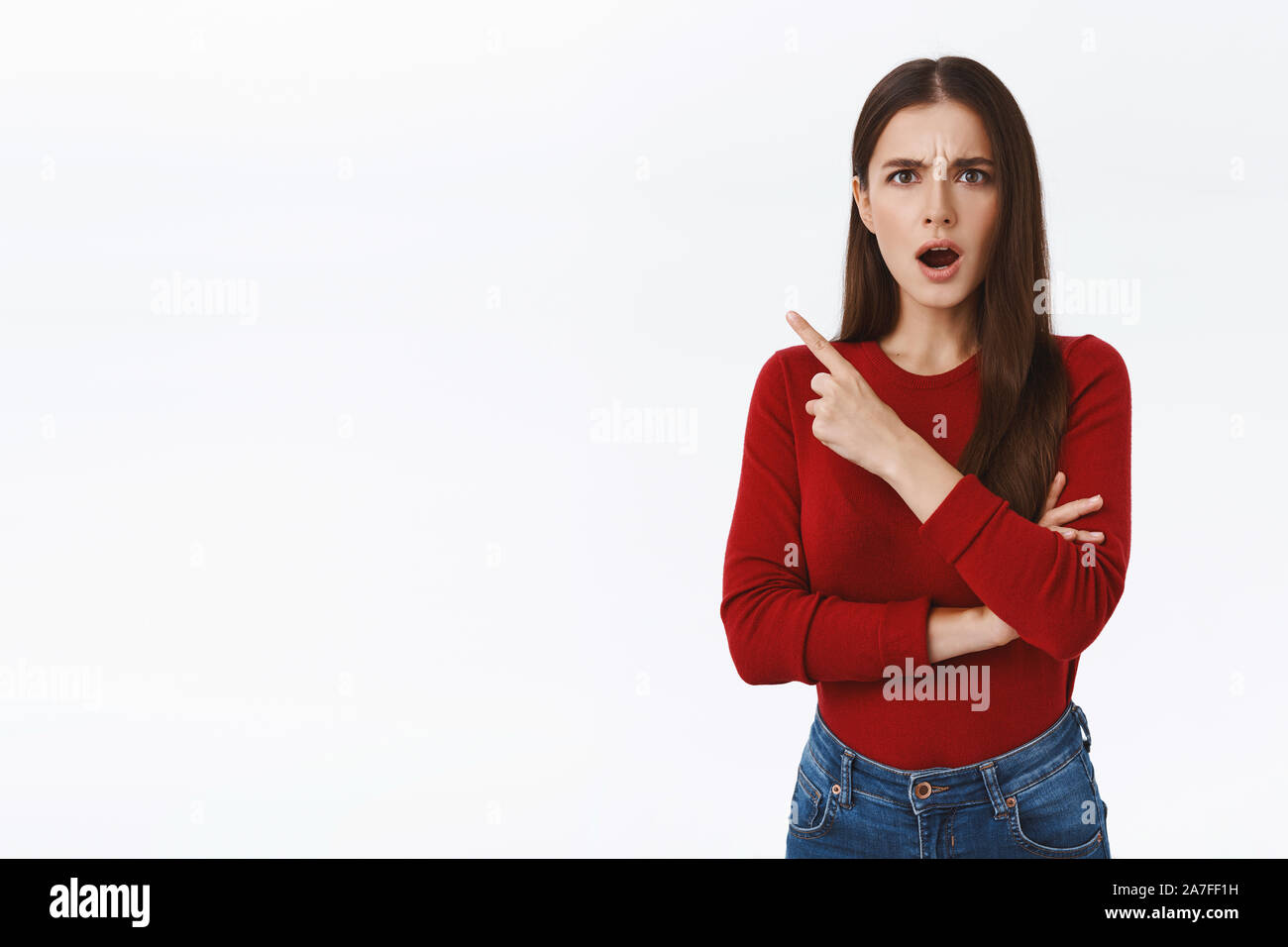 Shocked dissatisfied pretty, feminine brunette girl in red sweater ...