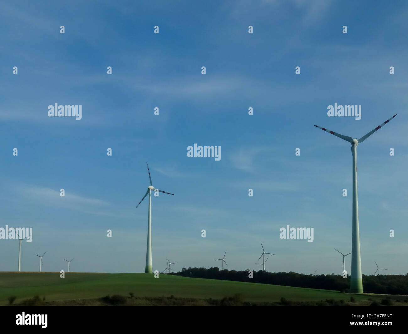 Wind turbines with blue sky generating renewable electricity Stock ...