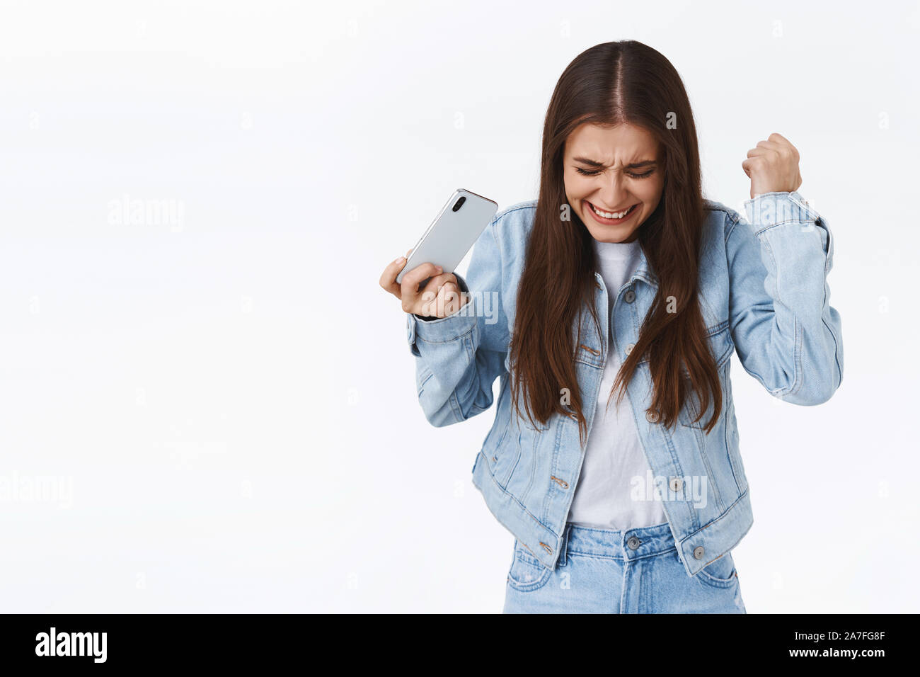 Happy attractive woman achieving goal, fist pump and celebrating ...
