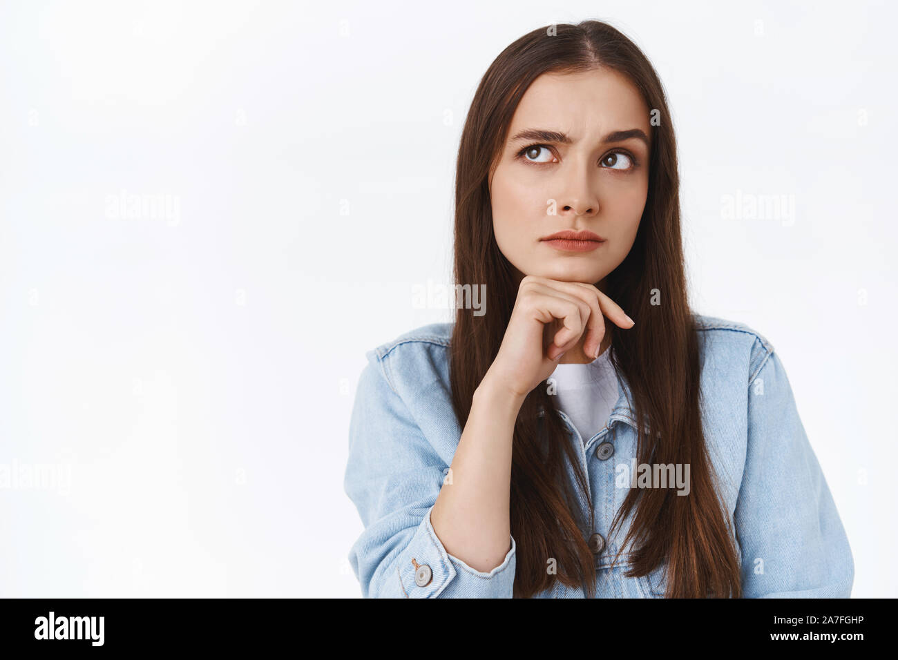 Thoughtful serious-looking determined and pensive 20s girl, touching ...