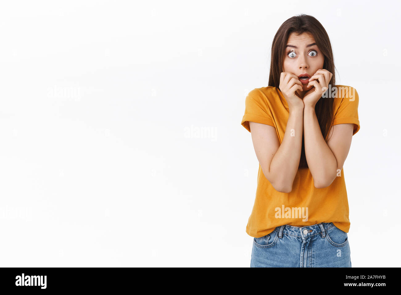 Scared, insecure shocked timid woman in yellow t-shirt, gasping stare ...