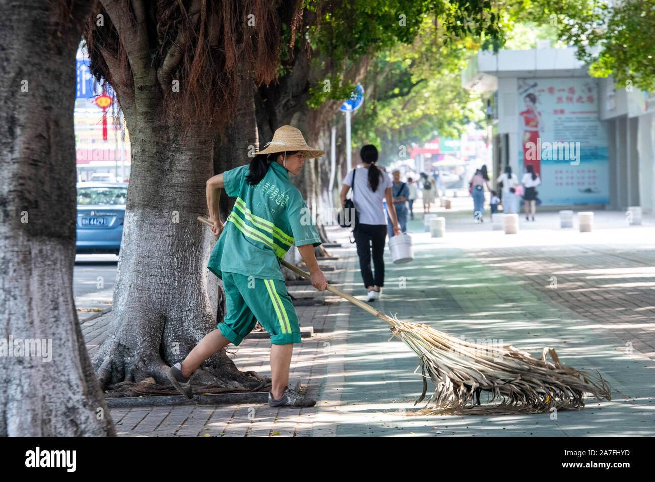 Woman sweeping sidewalk hi-res stock photography and images - Alamy