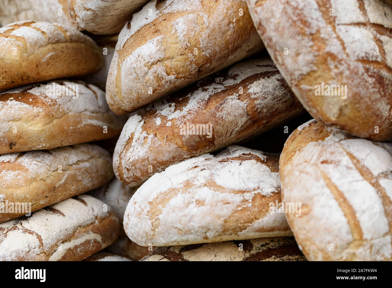 Pile of freshly baked wholemeal breads in the bakery or local farmer ...