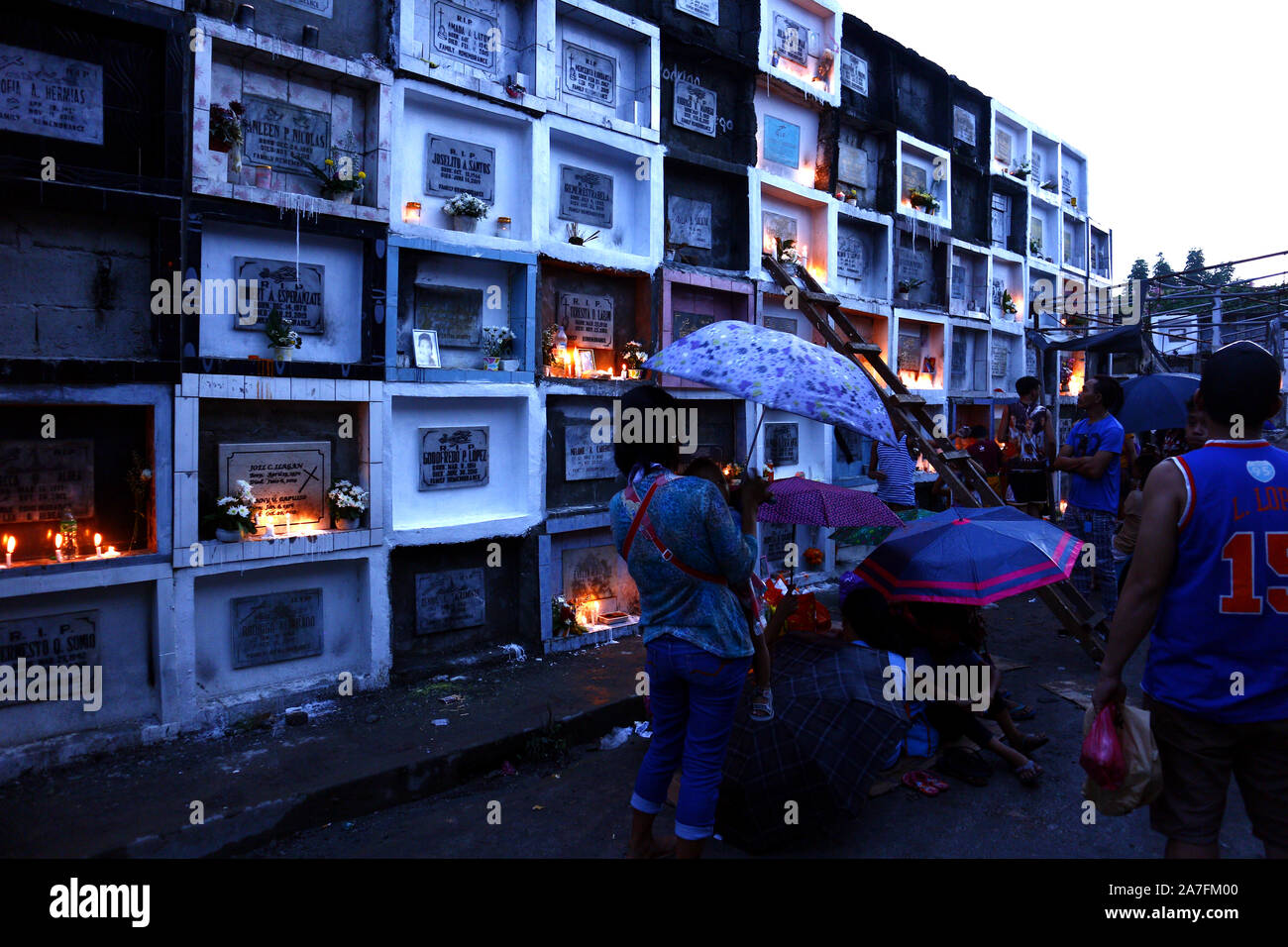 ANTIPOLO CITY, PHILIPPINES – NOVEMBER 1, 2019: People go to cemeteries ...