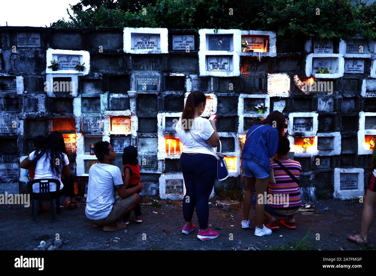 ANTIPOLO CITY, PHILIPPINES – NOVEMBER 1, 2019: People go to cemeteries ...