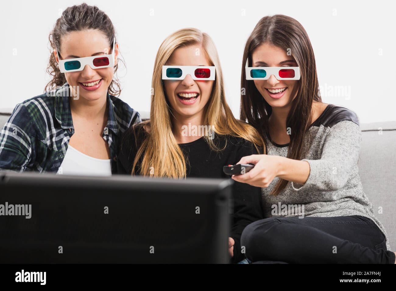 Group three girls watching tv hi-res stock photography and images - Alamy