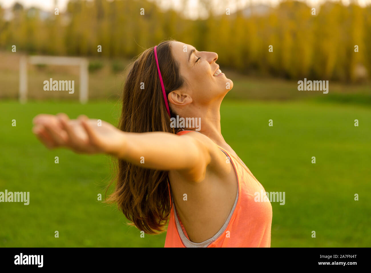 Beautiful woman in nature open her arms and smiling Stock Photo - Alamy