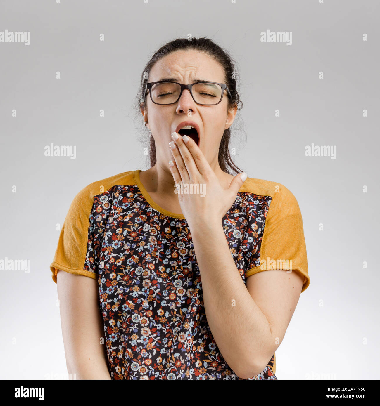 Cute portrait of beautiful woman yawning Stock Photo - Alamy