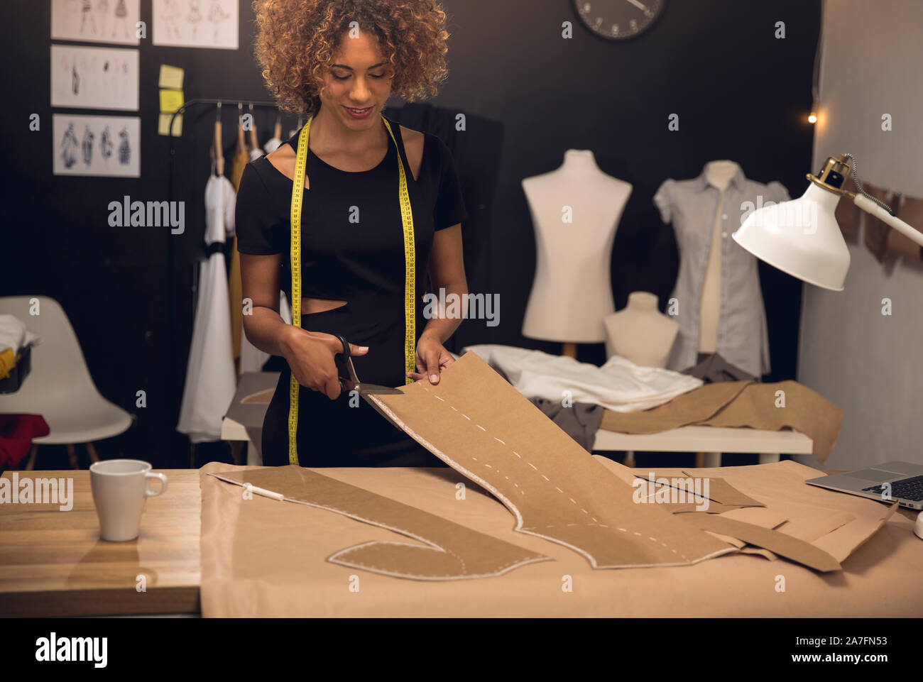 A young fashion designer working on her atelier Stock Photo - Alamy