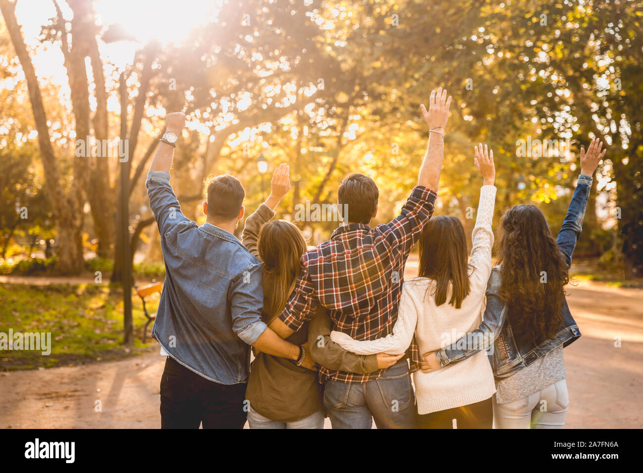 Casual group excited friends arms hi-res stock photography and images ...