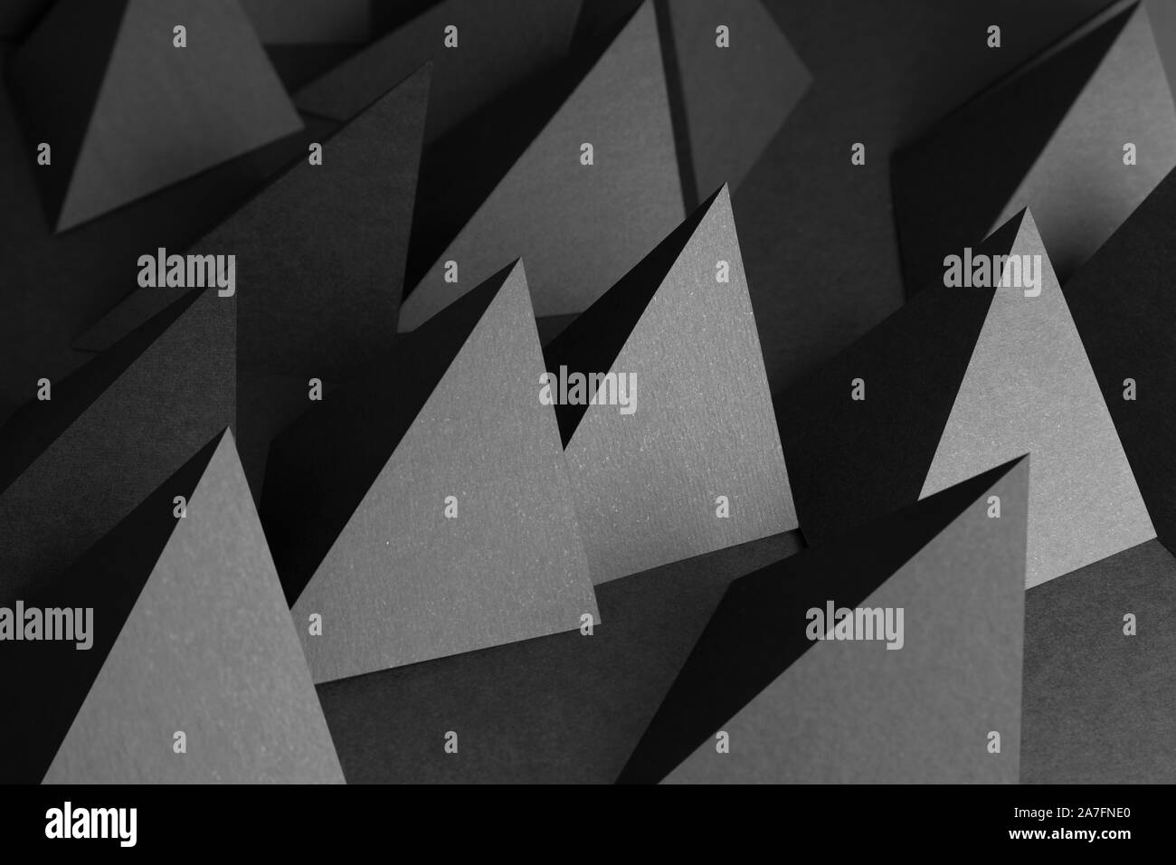 Pyramids of paper, dark abstract background Stock Photo - Alamy