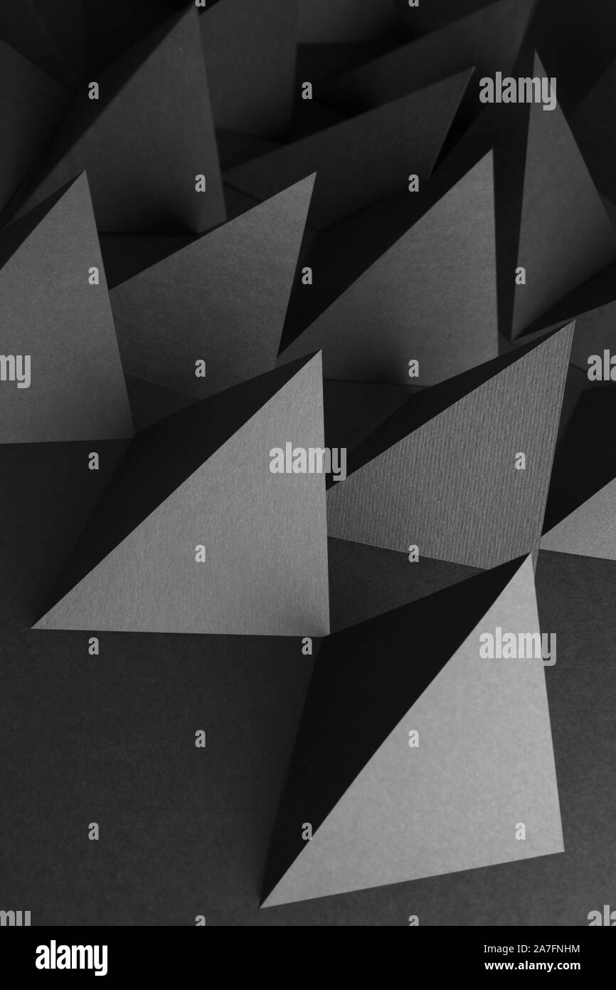 Pyramids of paper, dark abstract background Stock Photo - Alamy