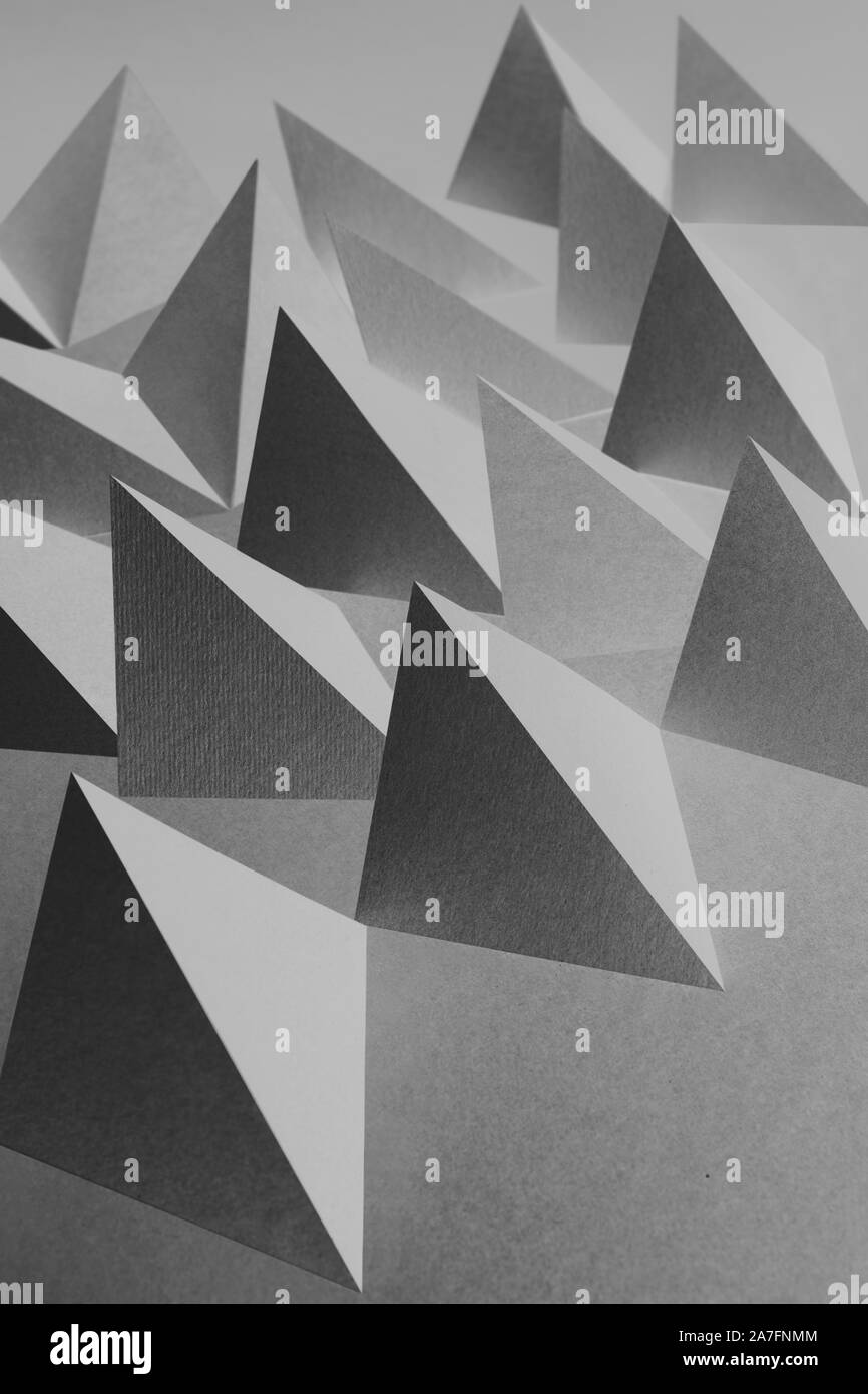 Pyramids of paper, dark abstract background Stock Photo - Alamy