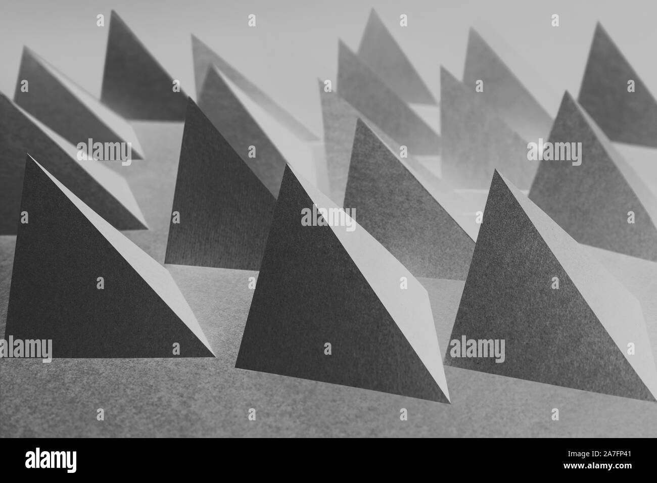Pyramids of paper, dark abstract background Stock Photo - Alamy