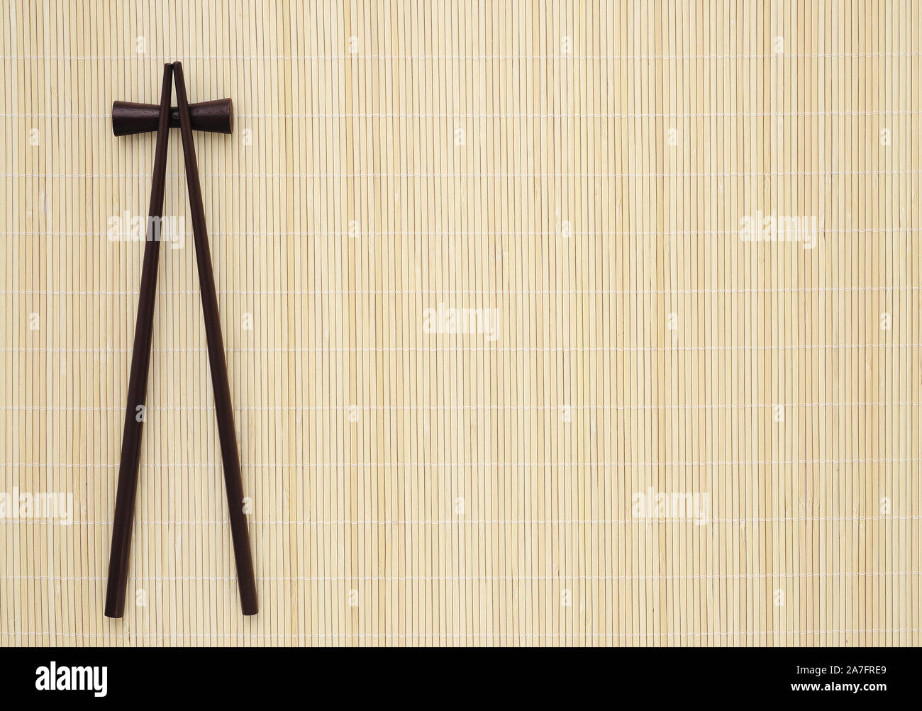 Bamboo mat with two dark brown sushi chopsticks. Menu Background Stock ...
