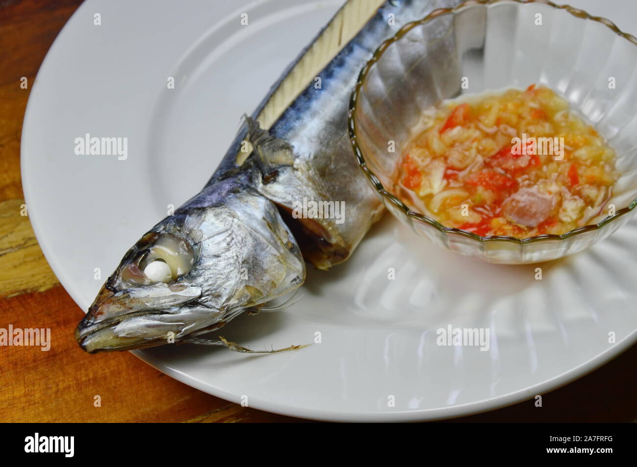 steamed Saba fish and spicy sauce on plate Stock Photo - Alamy