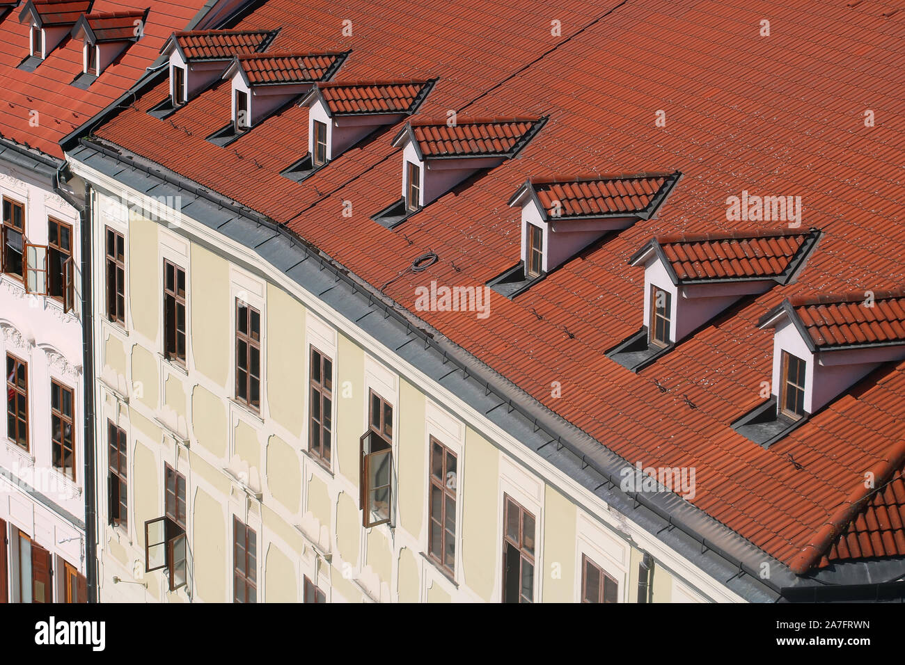Top view of old building with red roof and windows on the roof ...