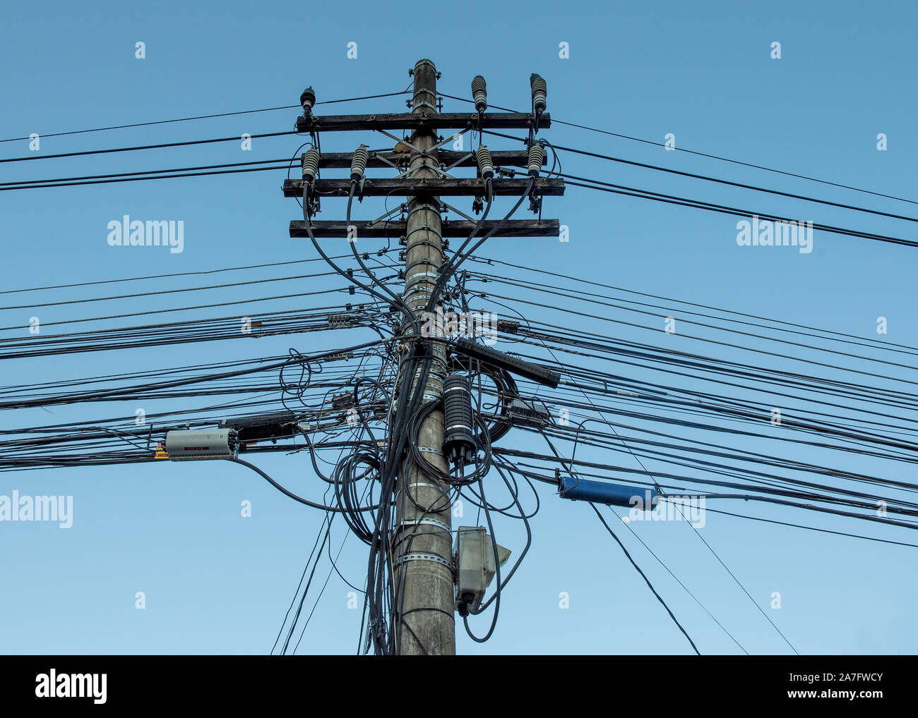 A mess of entangled electricity wires and pole, on a street in Brazil ...