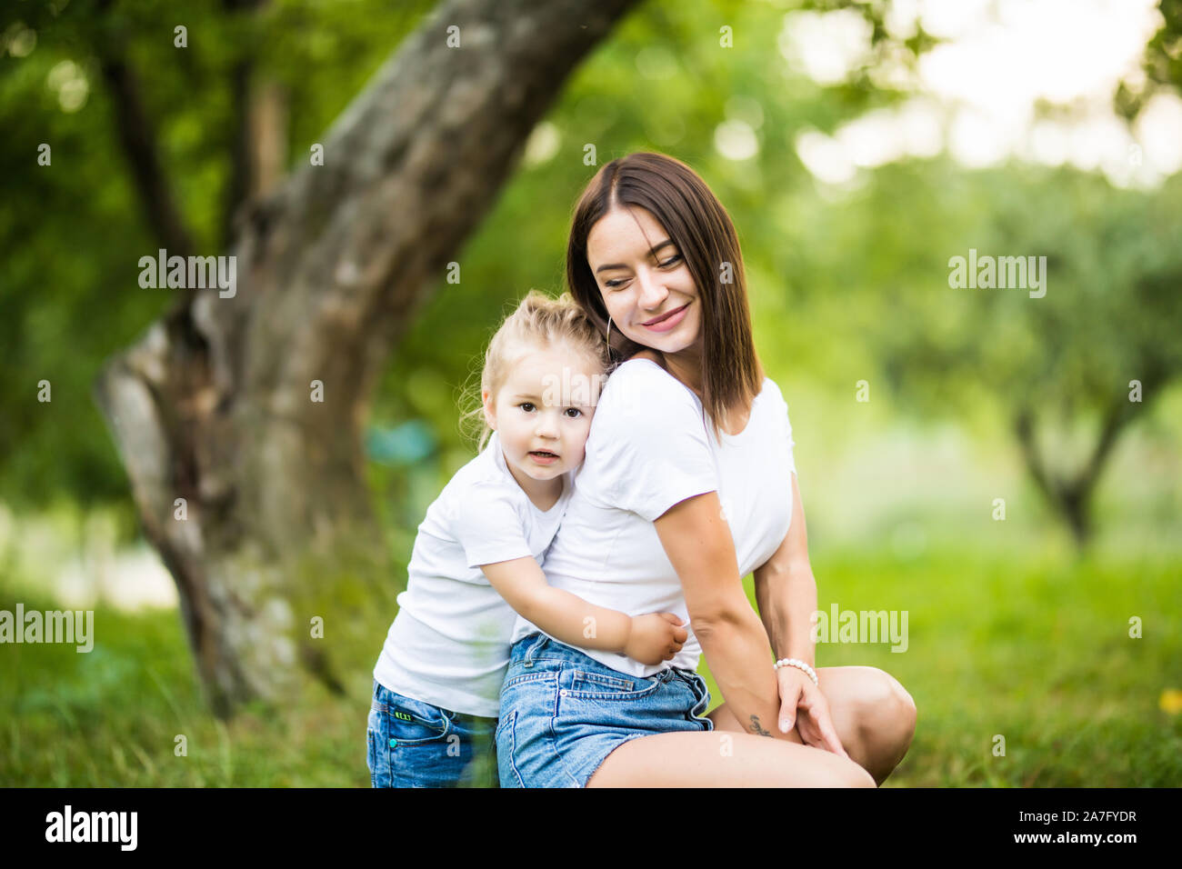 mother and daughter hugging in love playing in the park Stock Photo - Alamy