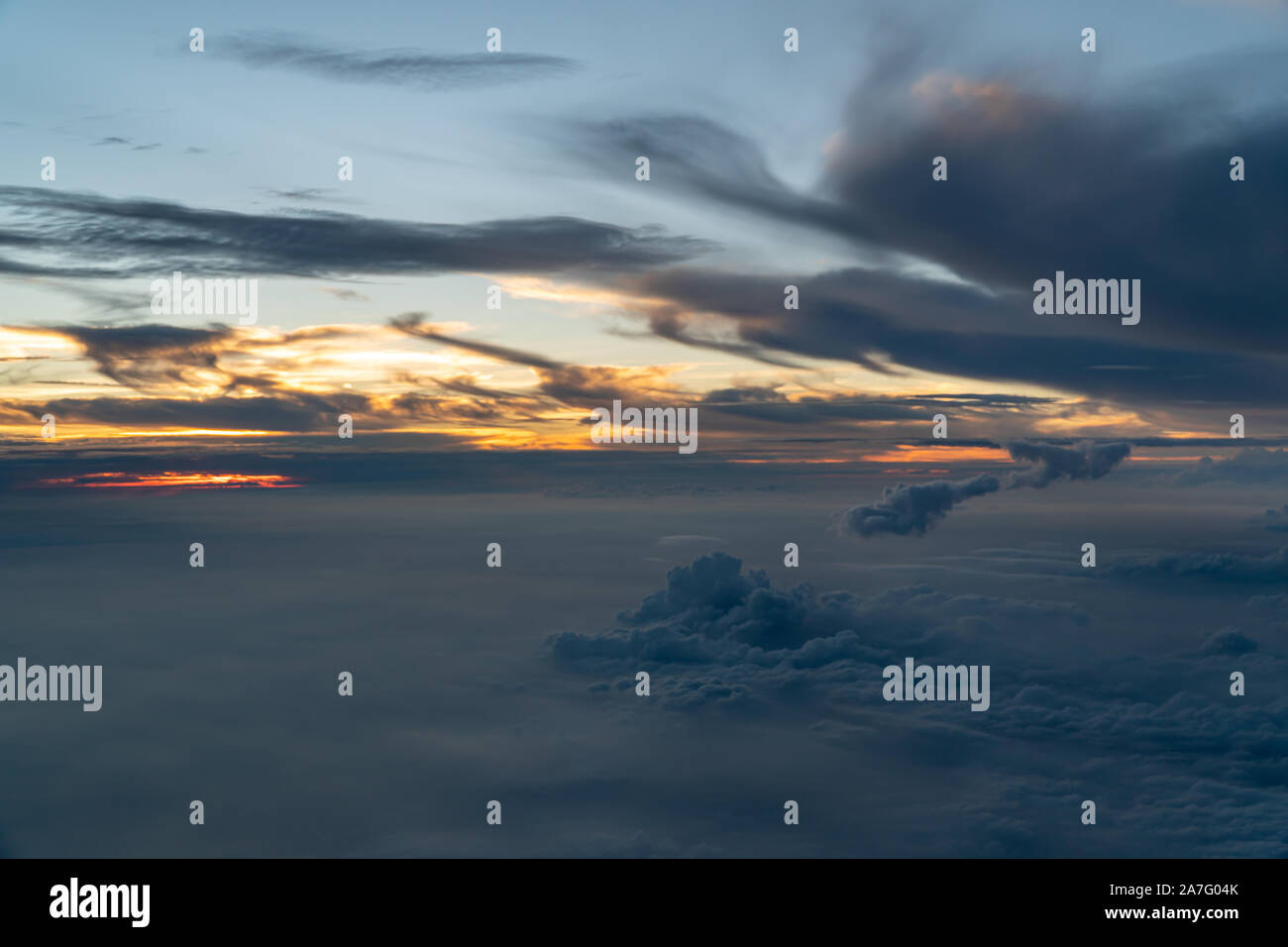 View from an airplane above the clouds during blue hour Stock Photo - Alamy