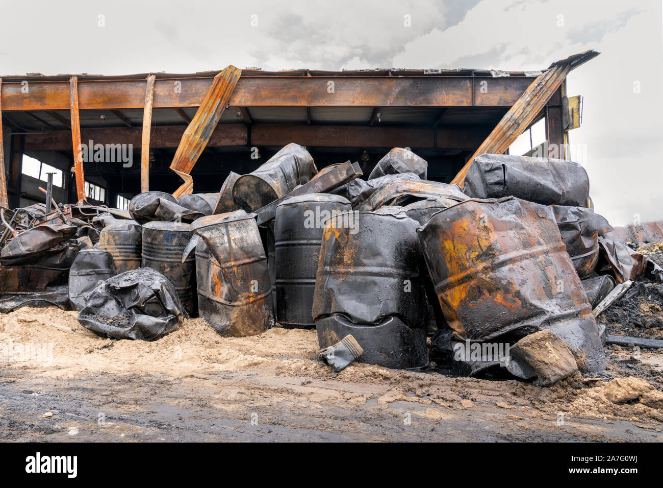 burnt charred barrels of engine oil on the background of the burned ...