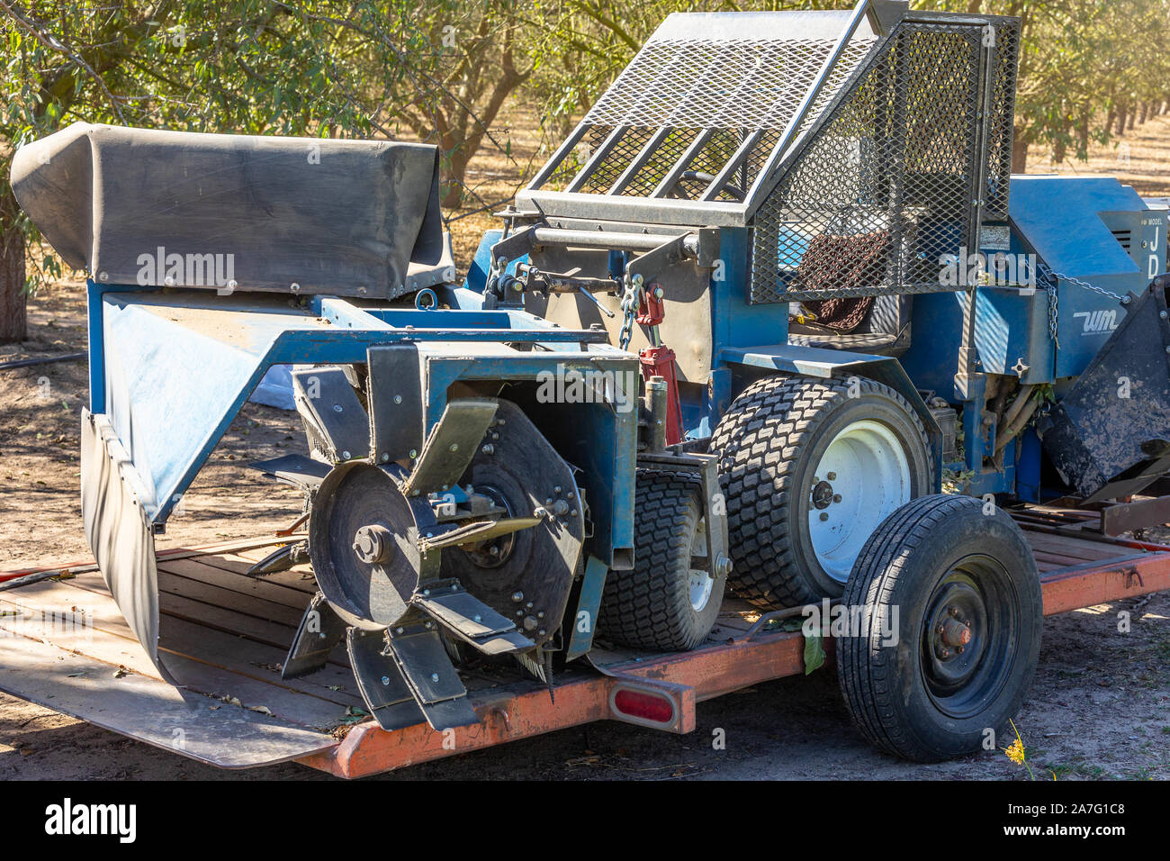Orchard Sweeping equipment that concentrates the almonds into rows that ...