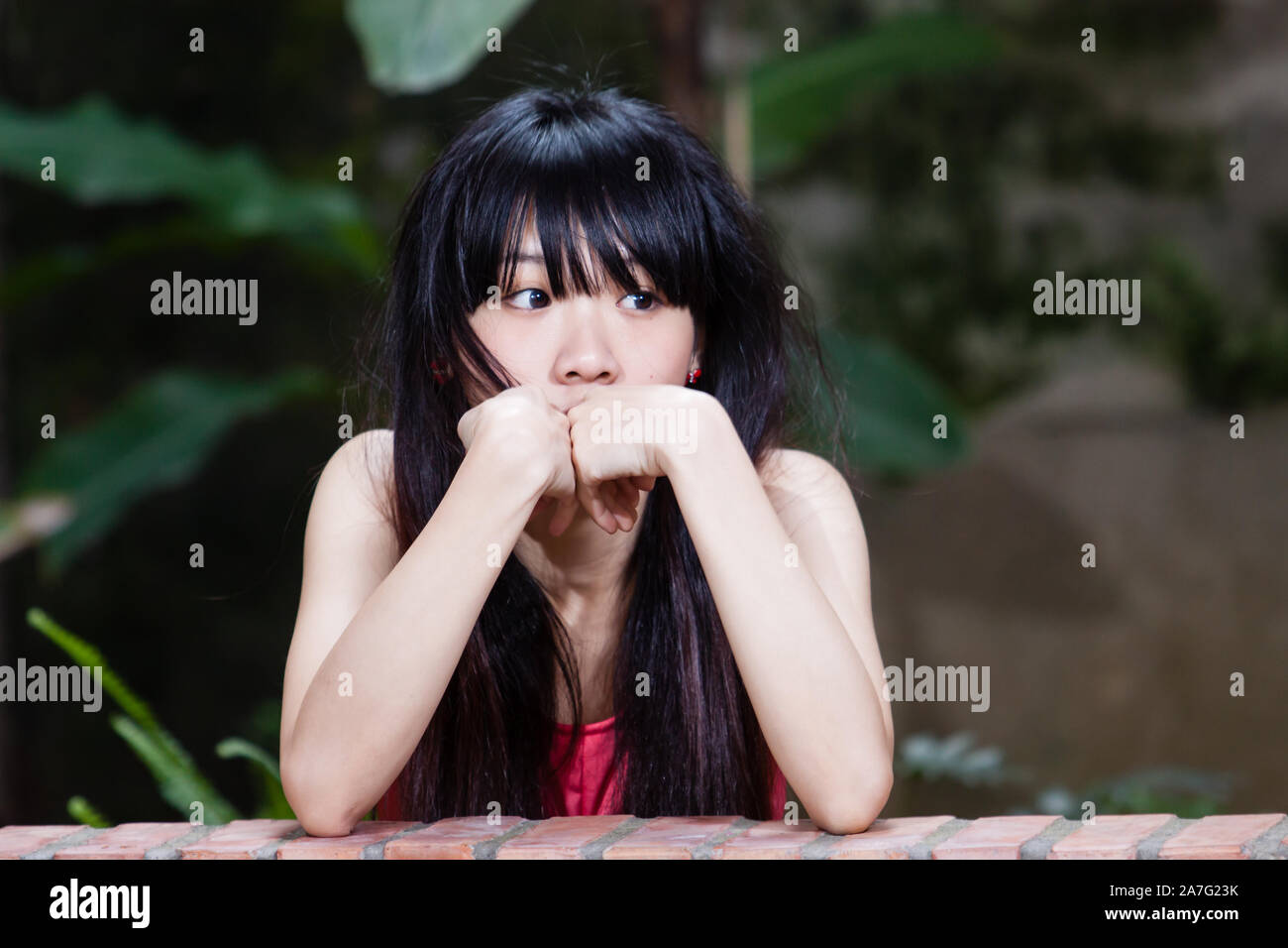 Asian American woman looks sad and forlorn Stock Photo - Alamy