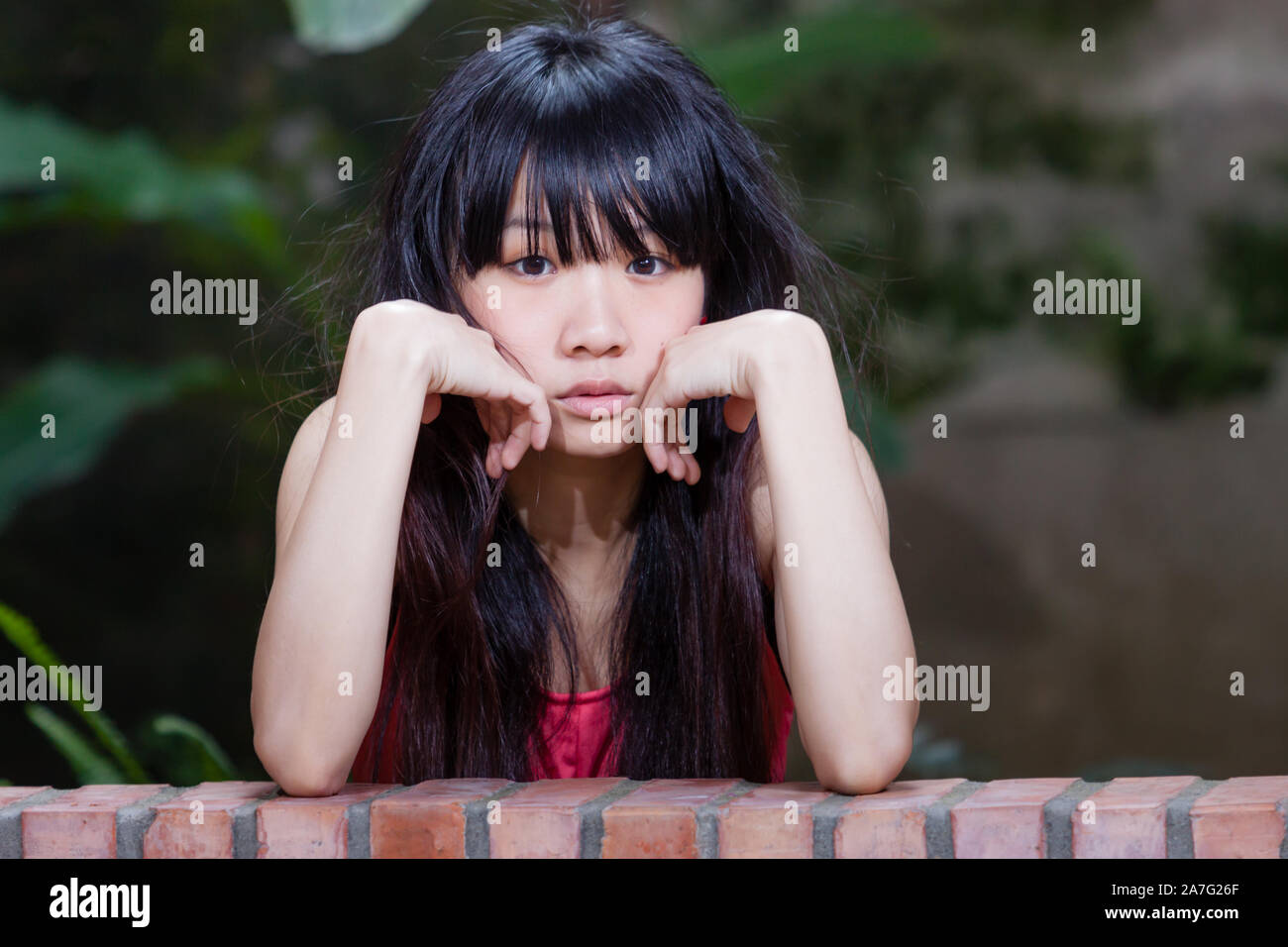 Asian American woman looks sad and forlorn Stock Photo - Alamy