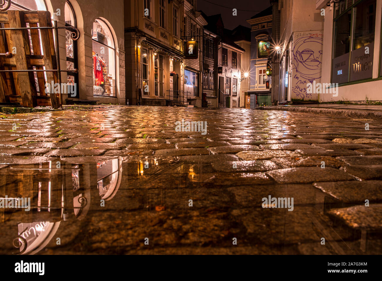 Wet cobblestone alley at night Stock Photo - Alamy