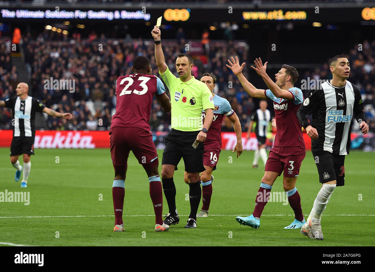 Referee Stuart Attwell gives West Ham United's Issa Diop (left) a ...