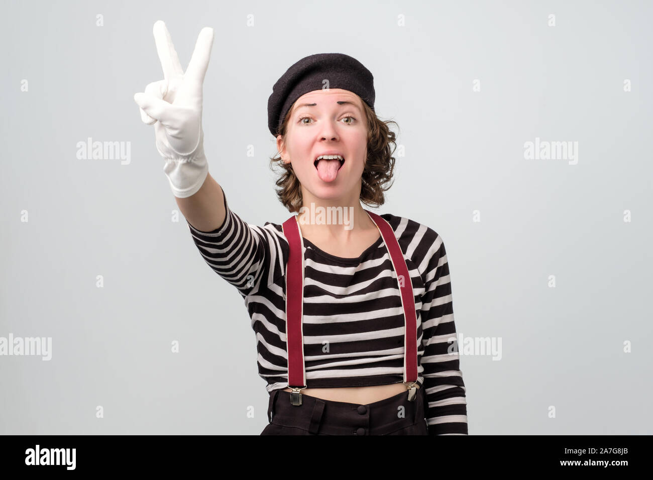 Caucasian mime woman showing victory gesture at isolated background ...