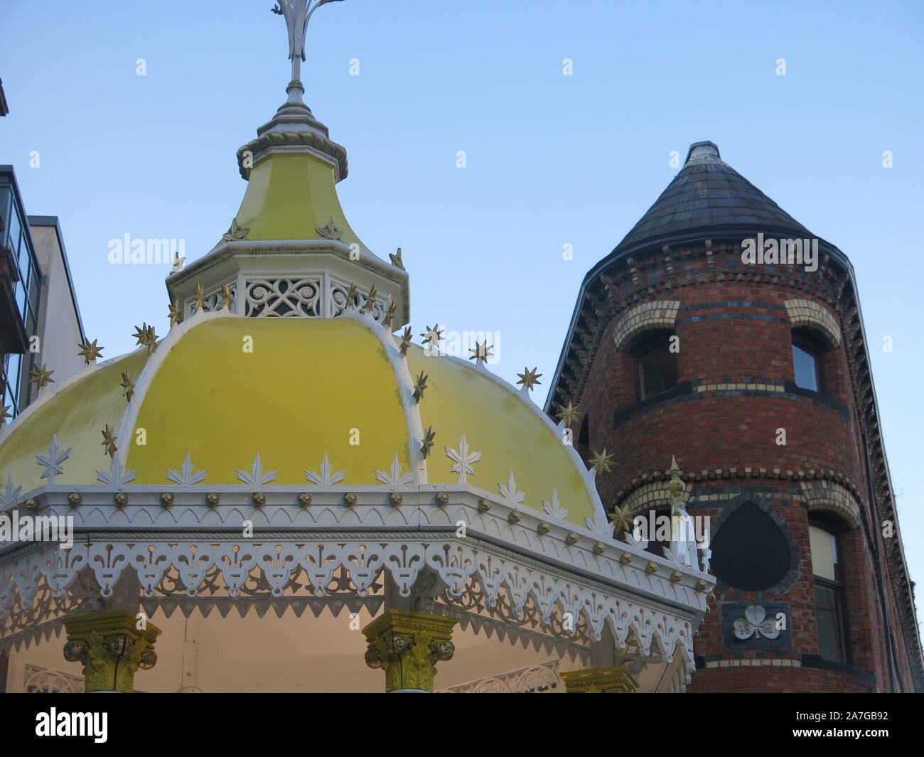 View of the ornate yellow fountain outside the flatiron building at ...