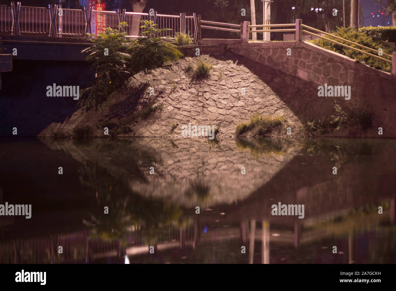 Water mirror reflection resembling a strange face Stock Photo - Alamy