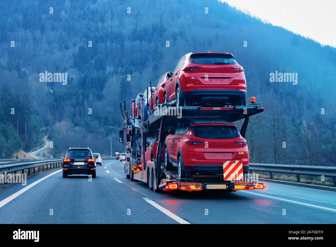 Cars carrier transporter truck on road Auto vehicles Stock Photo - Alamy