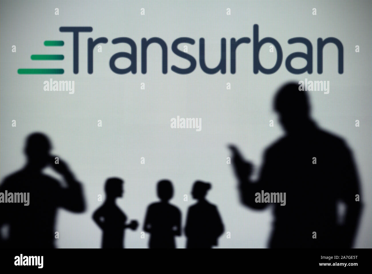 The Transurban logo is seen on an LED screen in the background while a ...