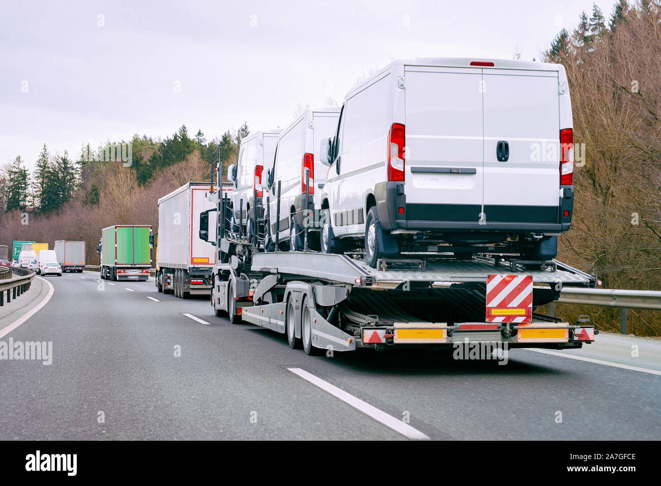 Minivan carrier transporter truck on road Auto vehicles Stock Photo - Alamy