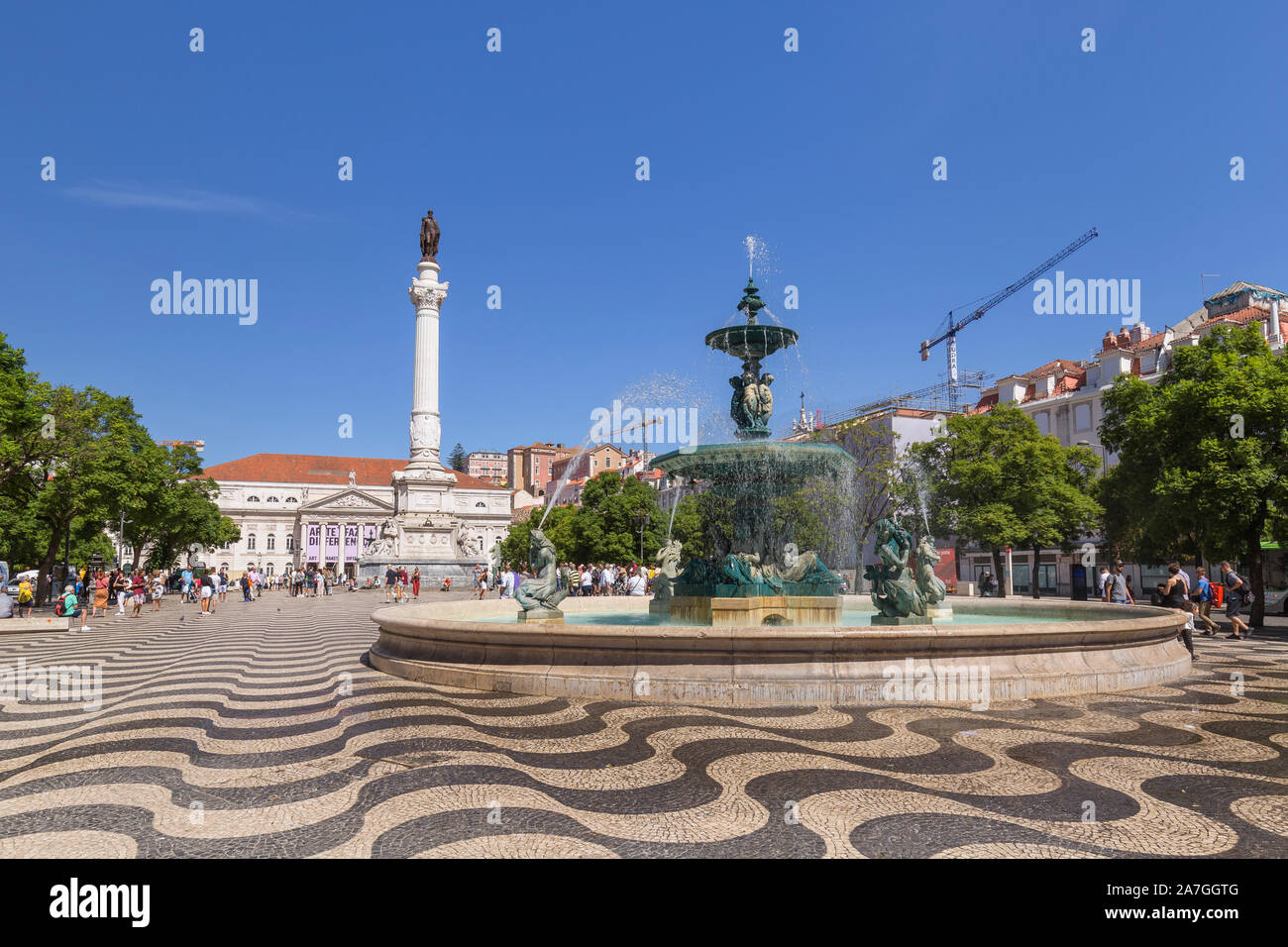 Fountain, tourists and Column and statue of Dom Pedro IV at the Rossio ...