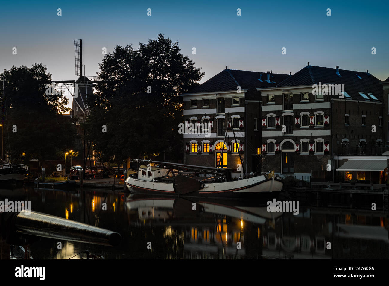 Calm scene of the old harbor of Gouda, Netherlands at dusk with dutch ...
