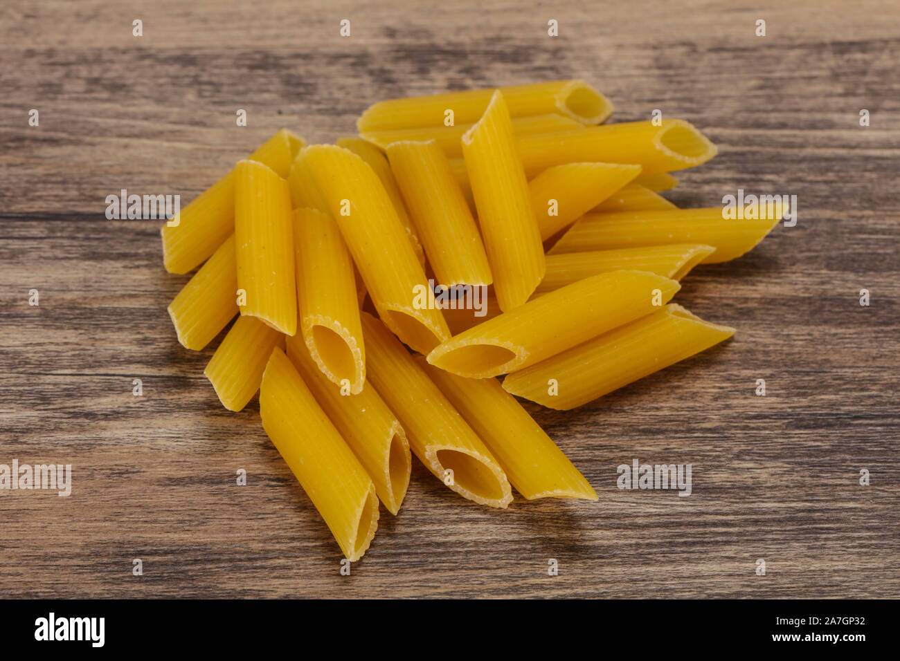 Raw penne pasta ready for bowl Stock Photo - Alamy