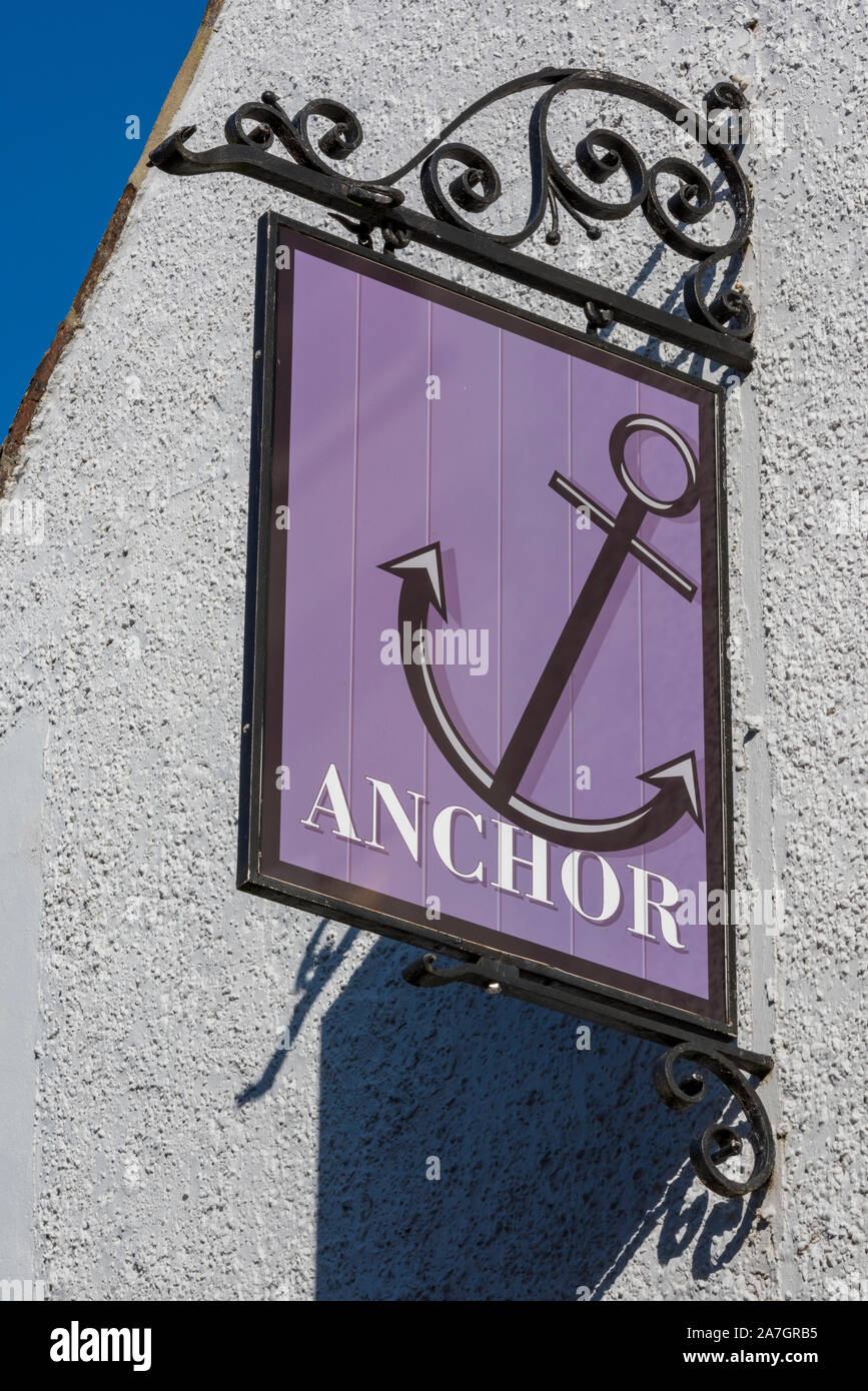 A pub sign painted with a nautical anchor Stock Photo - Alamy