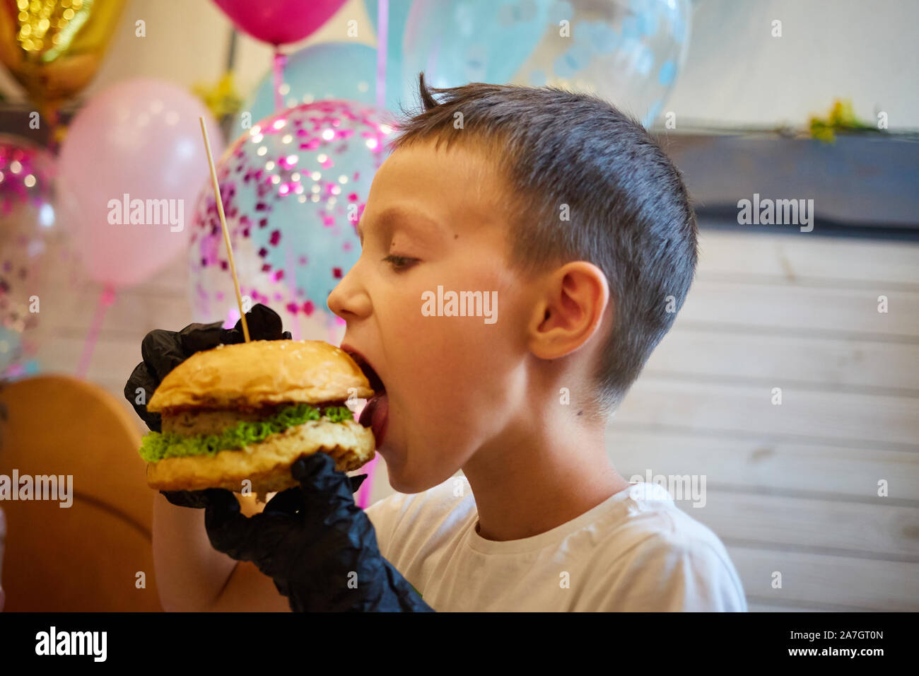 Kid Eating A Hamburger