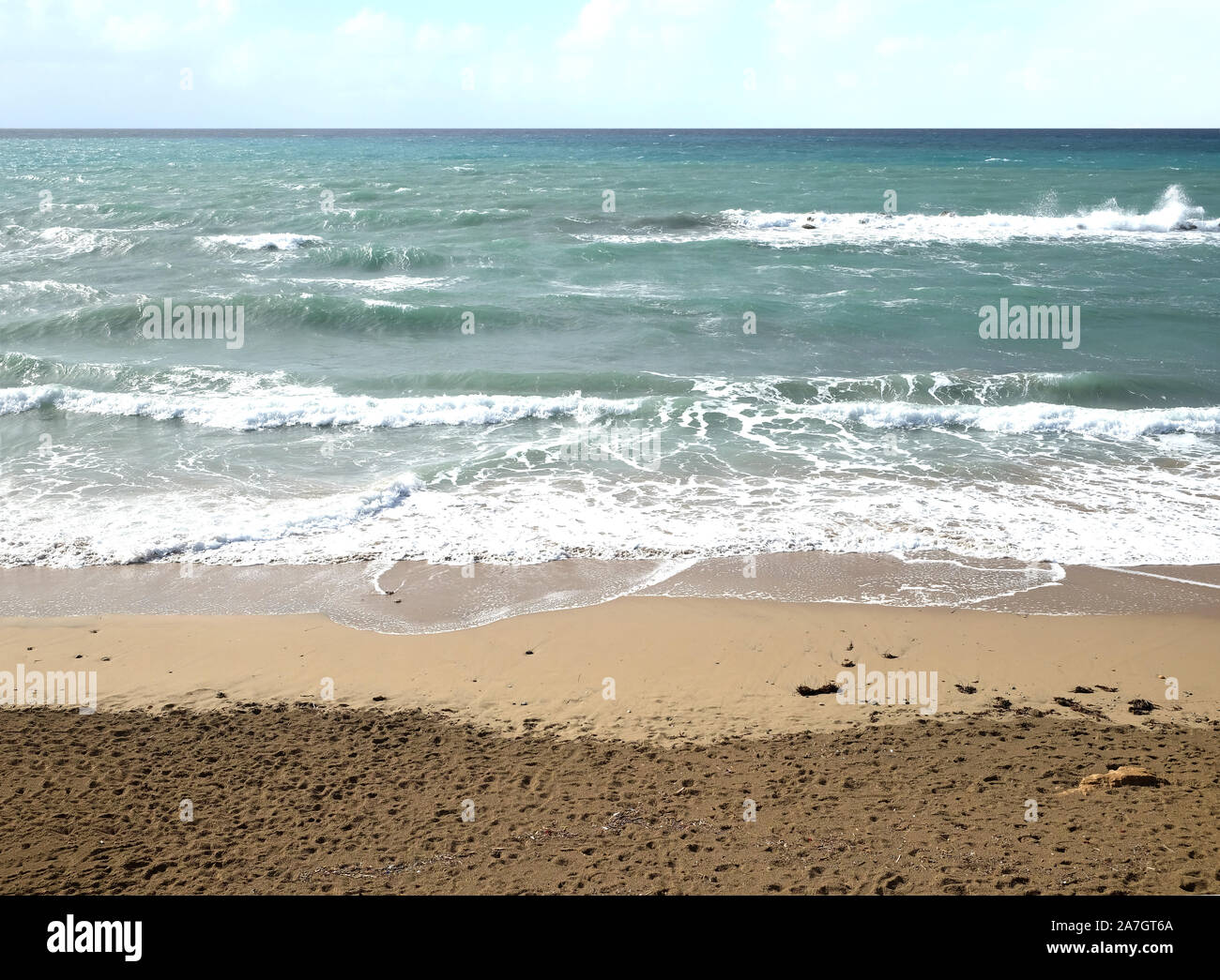 Landscape with sea surface with weaved small waves on sand beach on ...