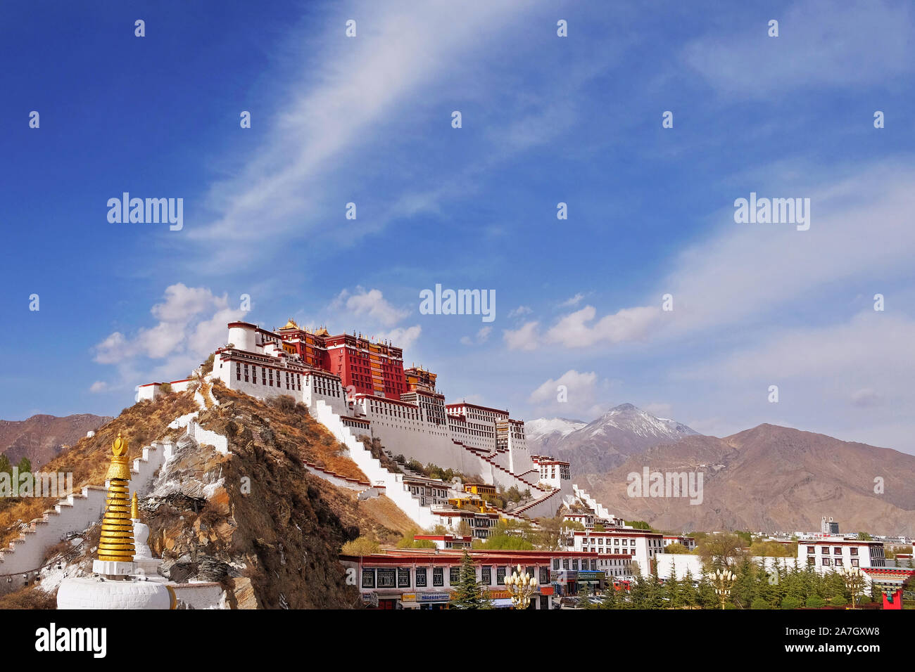 Lateral view of the Potala Palace in Lhasa, Tibet, surrounded by green ...