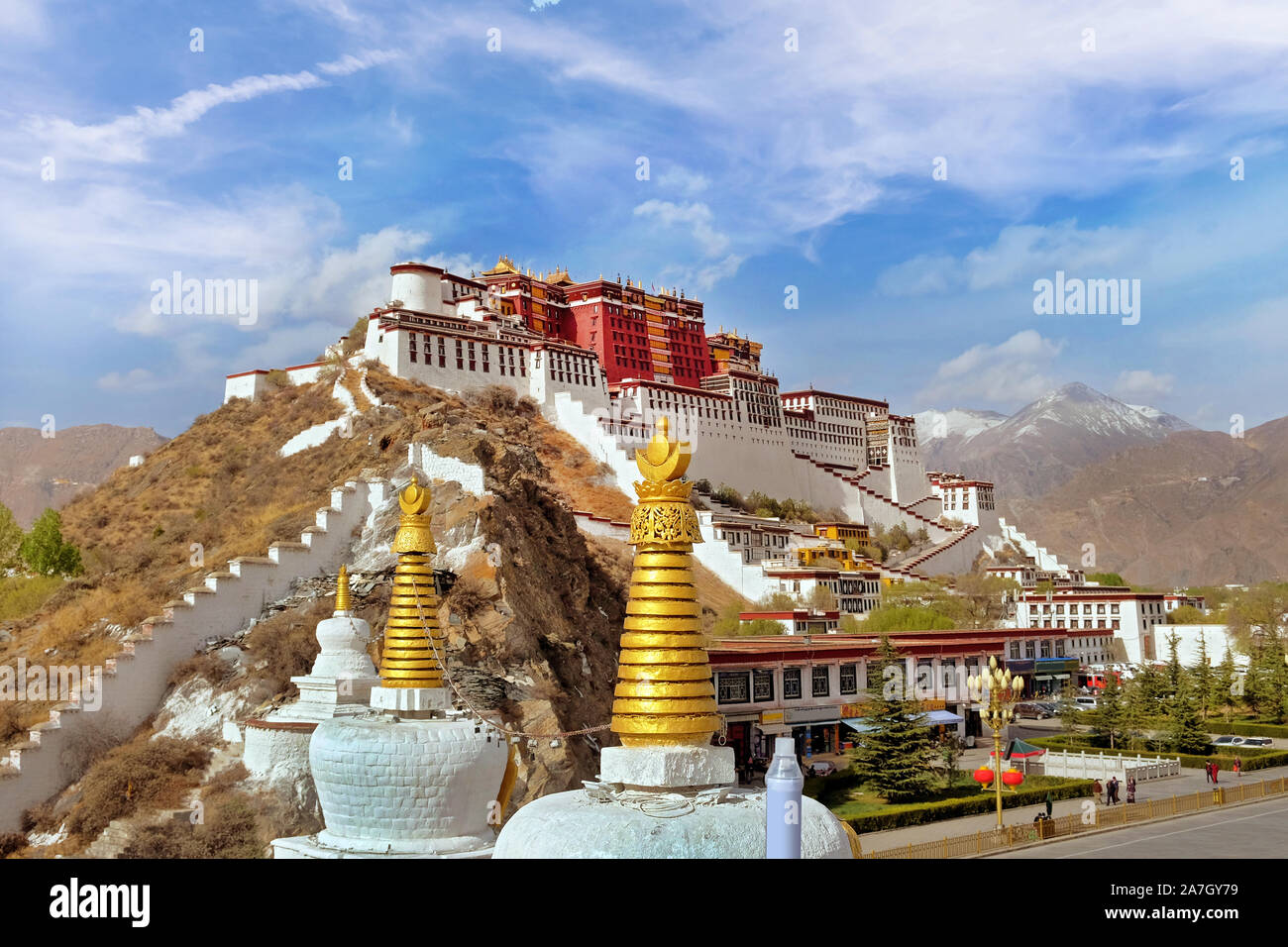 Lateral view of the Potala Palace in Lhasa, Tibet, surrounded by green ...