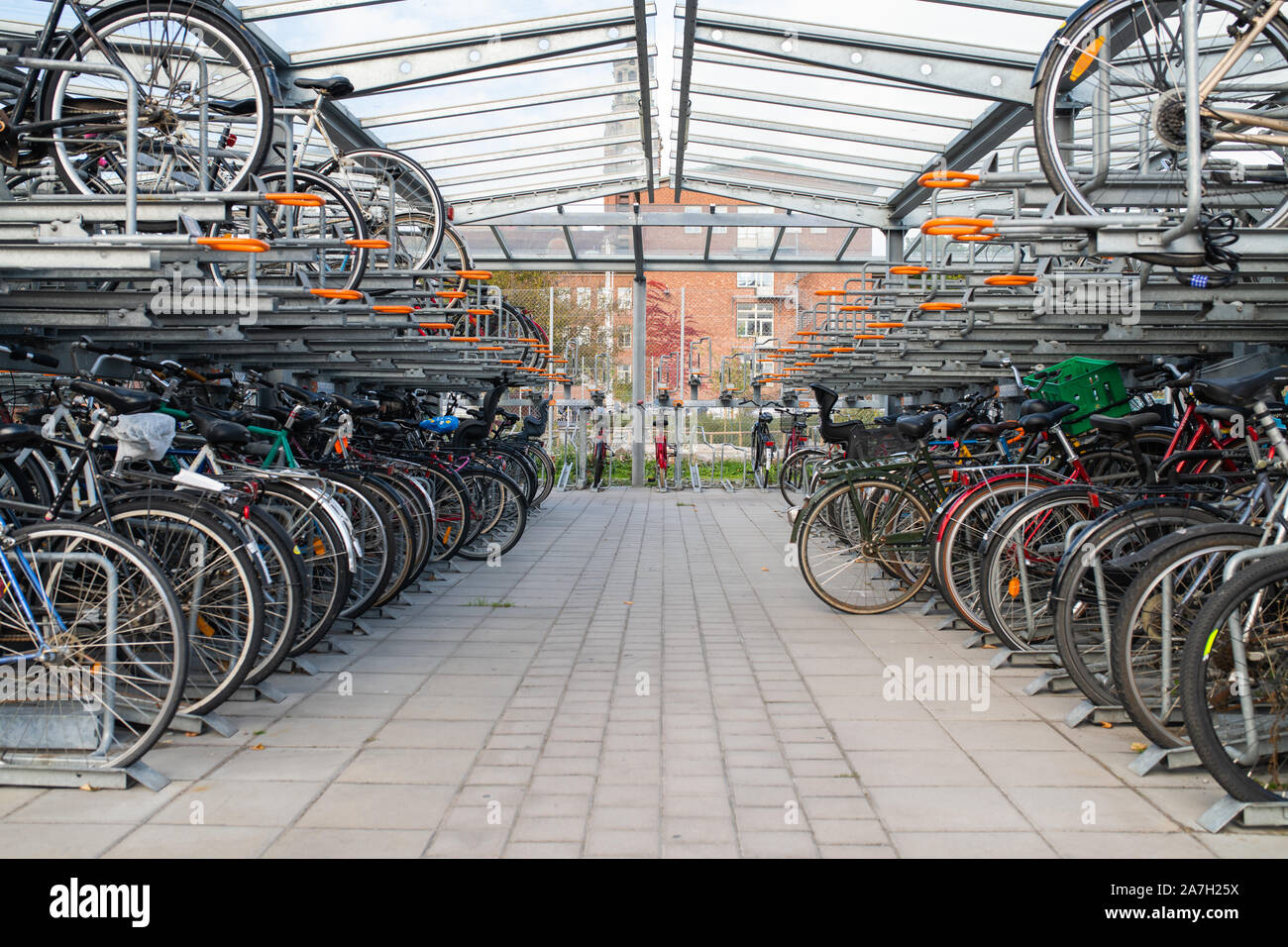 Many bikes stored in bicycle parking structure Stock Photo - Alamy
