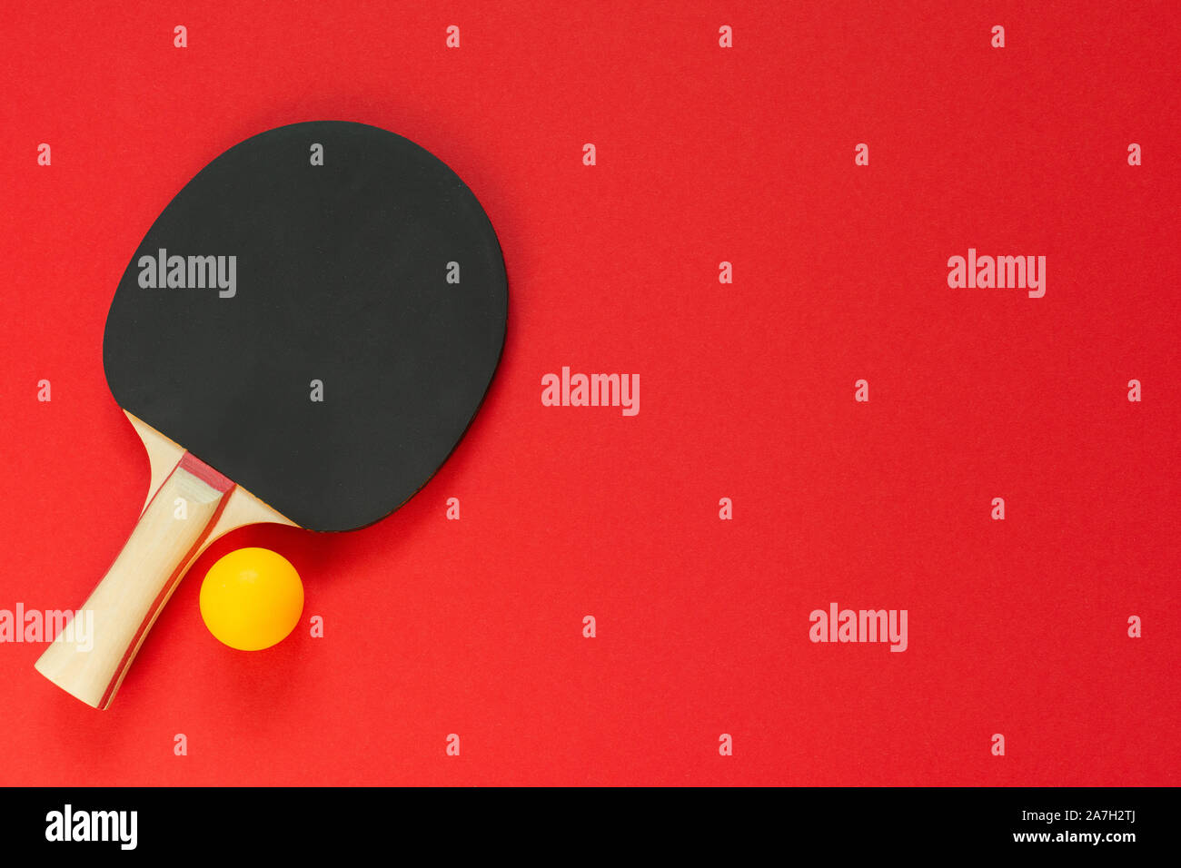 Black tennis ping pong racket isolated on a red background, sport ...